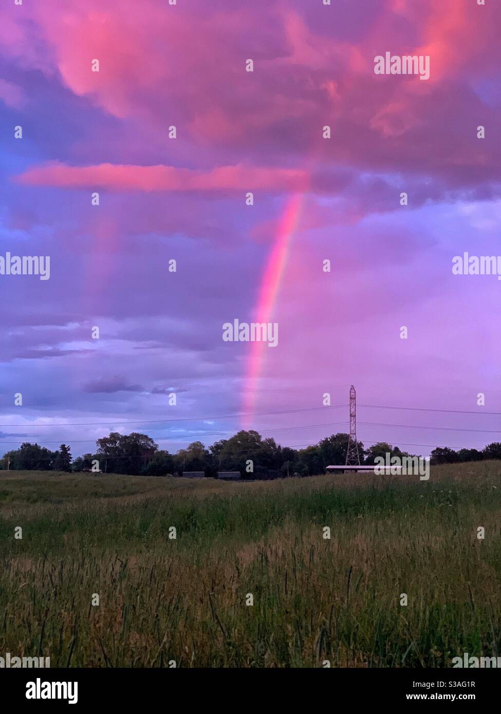 rainbow over field Stock Photo - Alamy