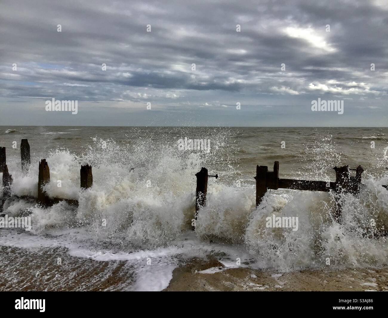 Breaking waves on break water Stock Photo - Alamy