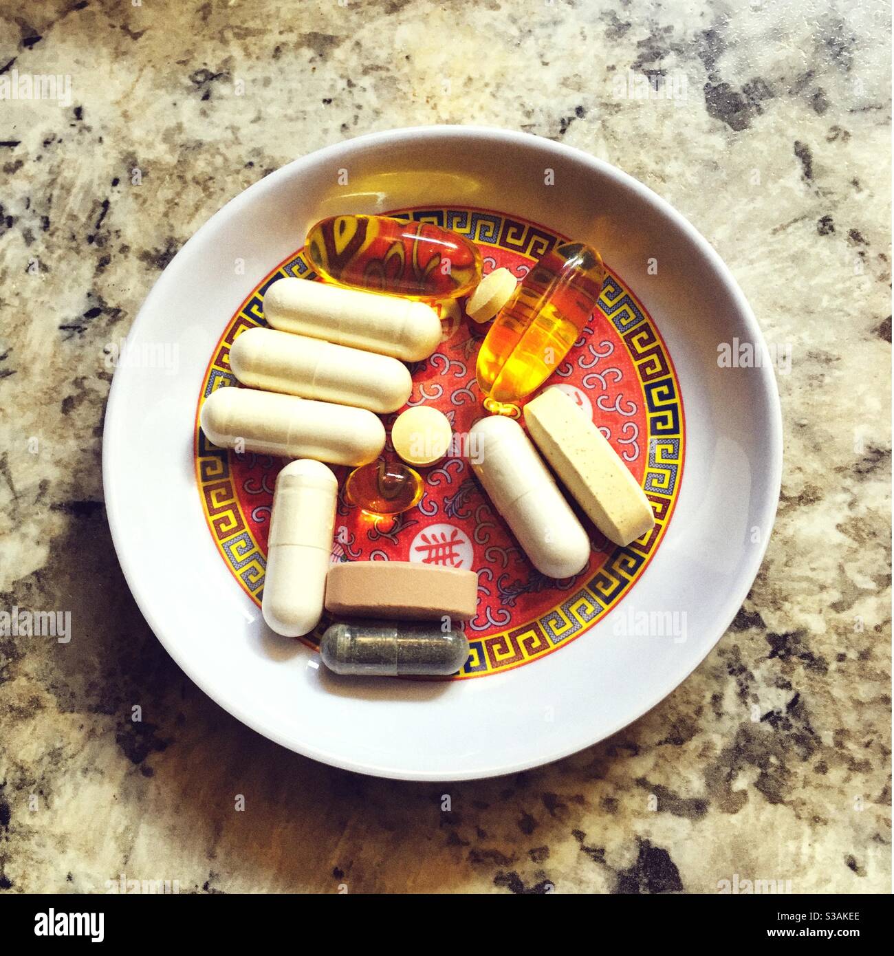 Vitamins in a small bowl Stock Photo - Alamy