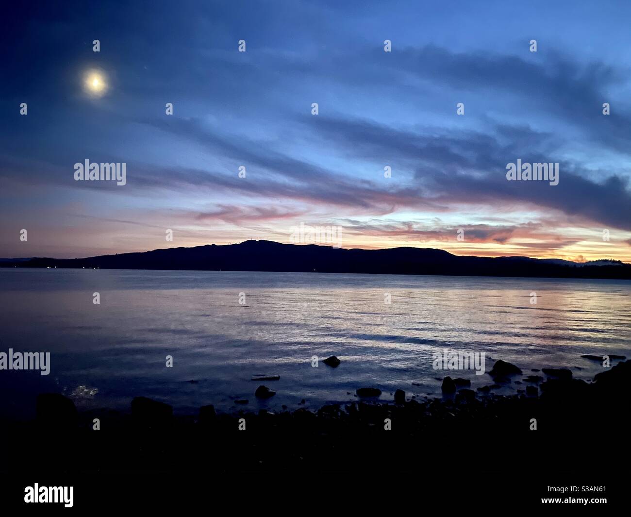 Moon over bay at dusk hi-res stock photography and images - Alamy