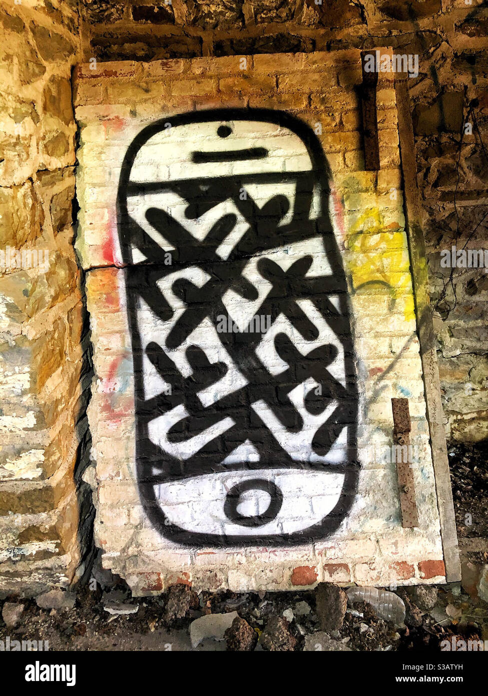 Painted graffiti of a cell phone in abandoned stone house Stock Photo ...