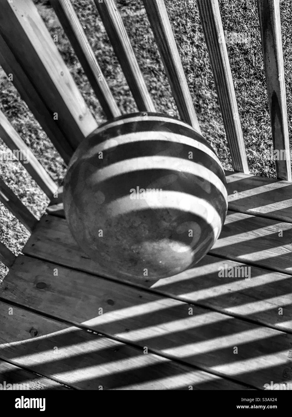 Morning shadows fall onto ball in black and white photo Stock Photo - Alamy