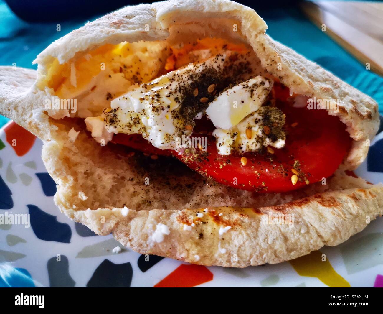 Lebanese pita bread stuffed with white cheese tomato za'atar and olive ...
