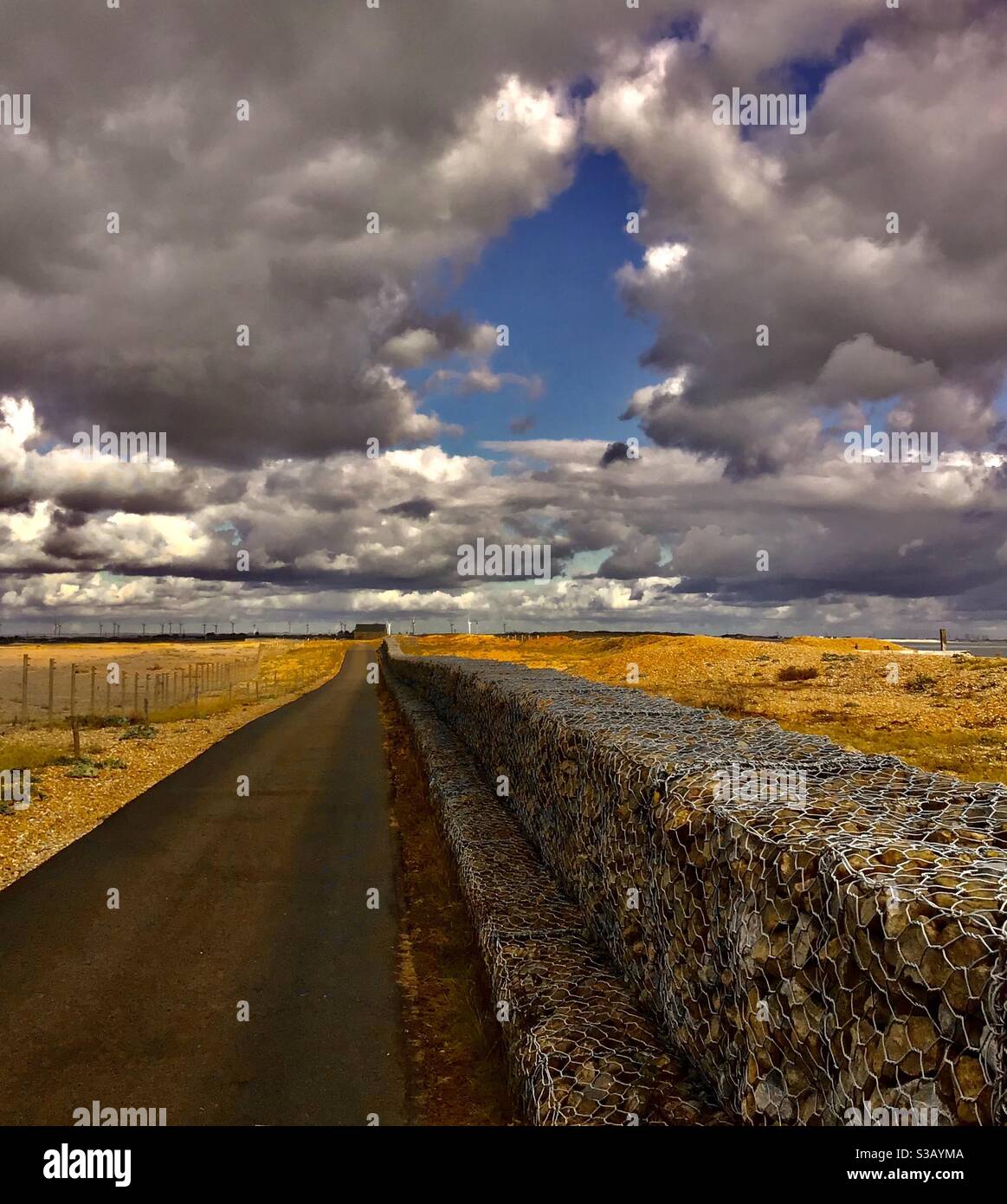 Coast path with stone tidal barrier Stock Photo - Alamy