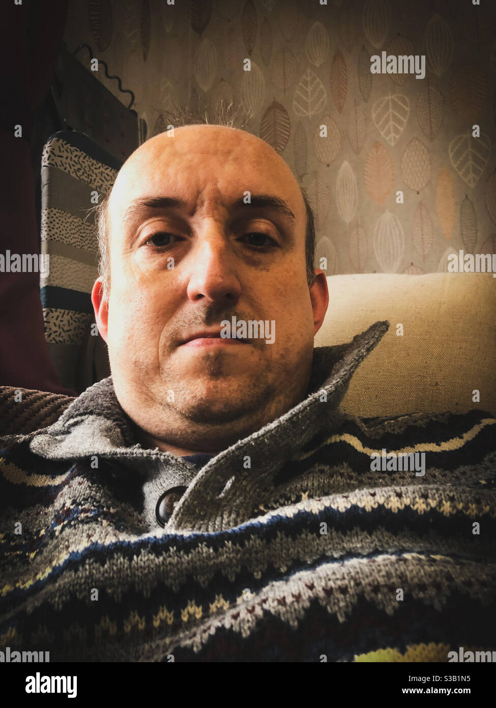 Self portrait of a middle aged man with stubble wearing a thick jumper ...