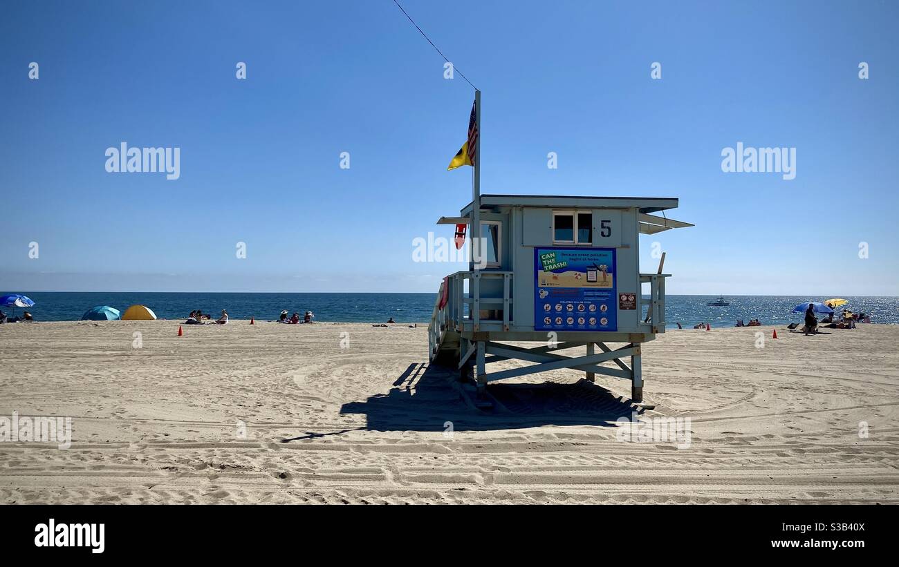 Lifeguard hut and sunbathers on beach by the Pacific Ocean in Malibu ...