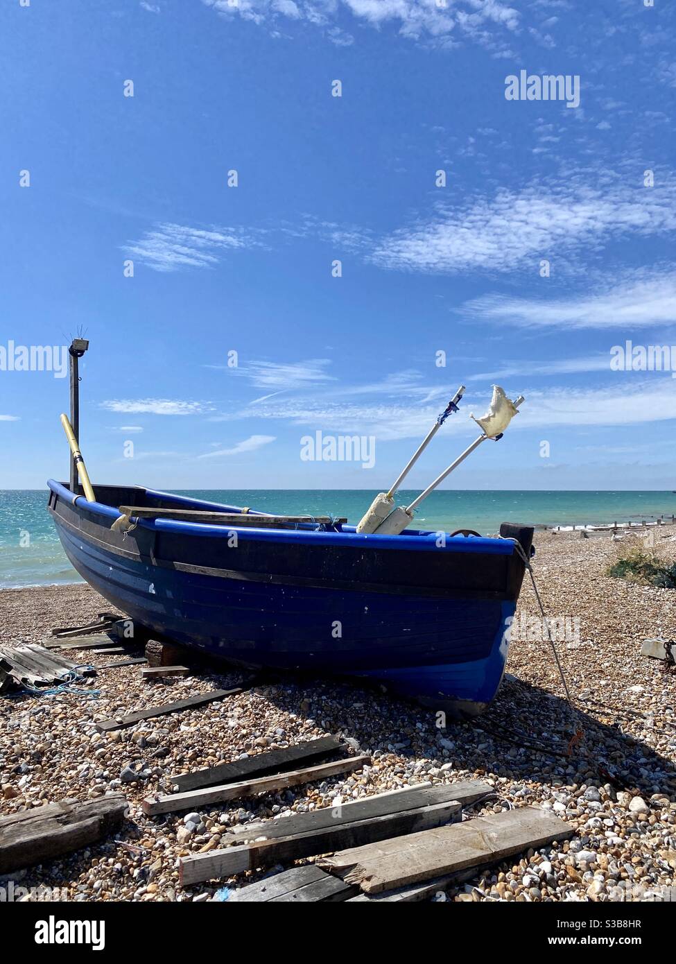 Pebble beach with a boat hi-res stock photography and images - Alamy