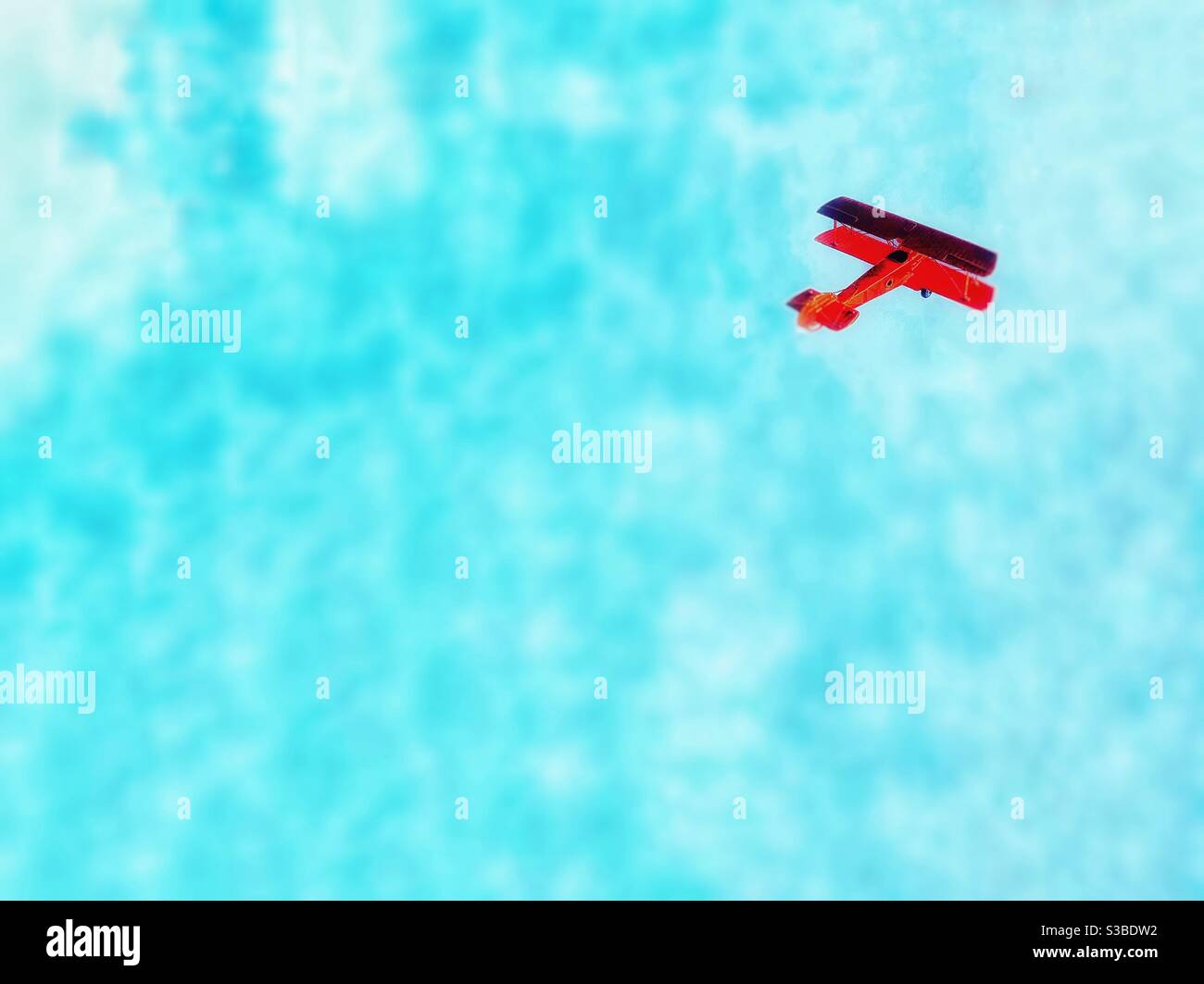 Red plane, blue sky Stock Photo - Alamy