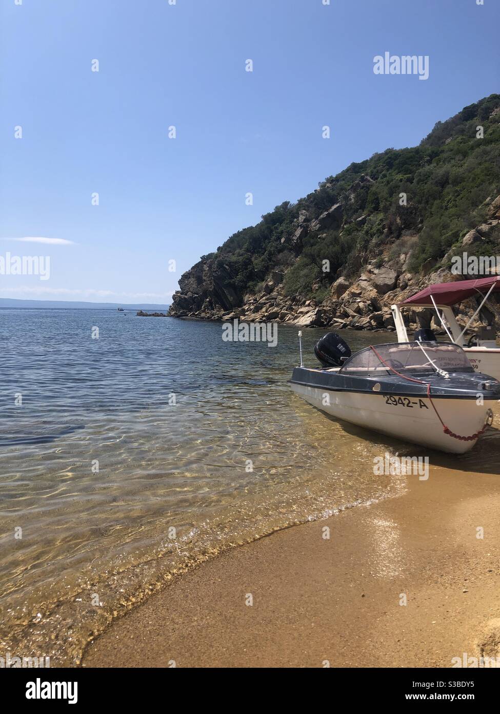 Chilling by the beach right next to the boat Stock Photo - Alamy