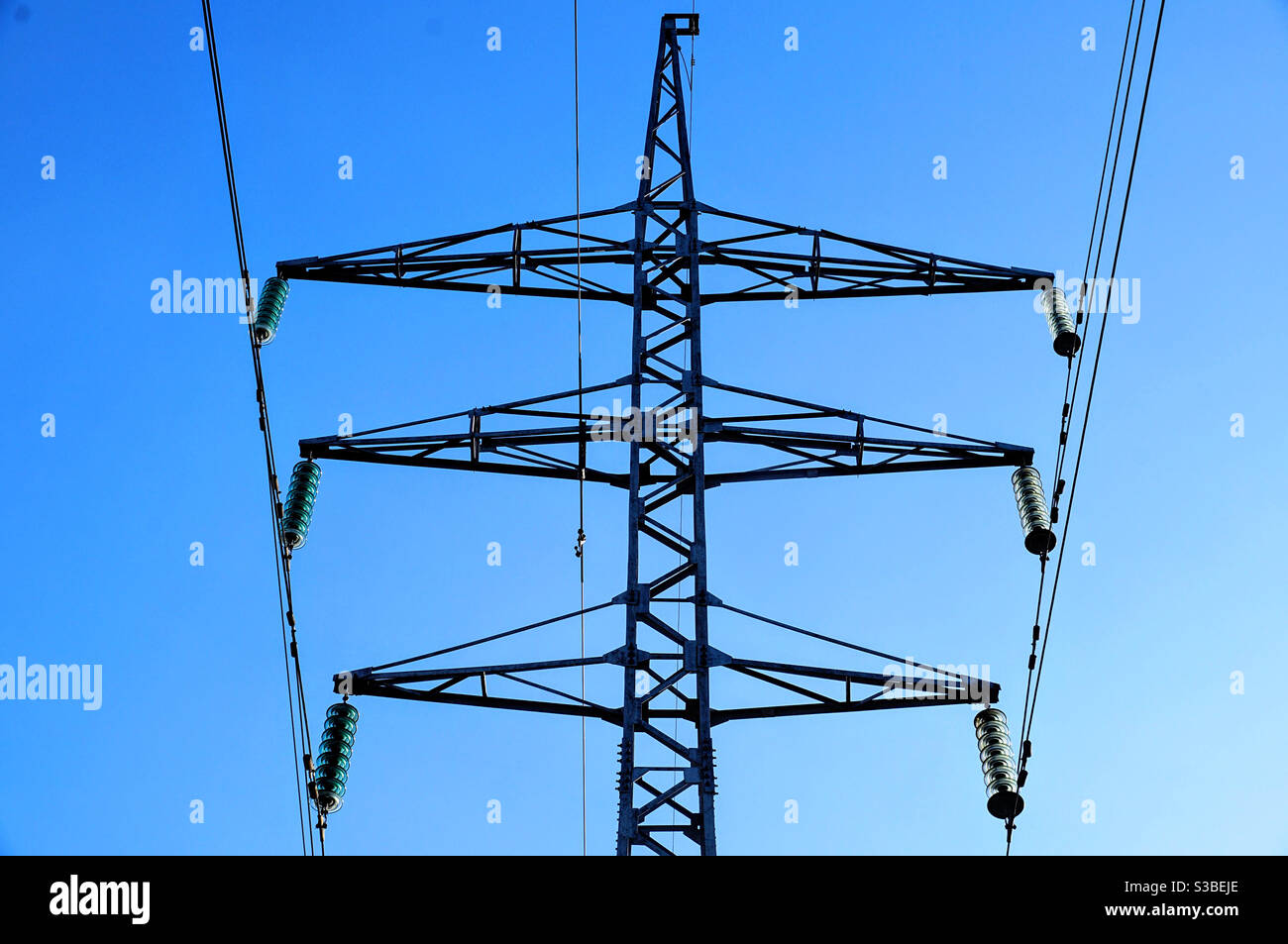The top of a power line tower against a clear sky background Stock ...