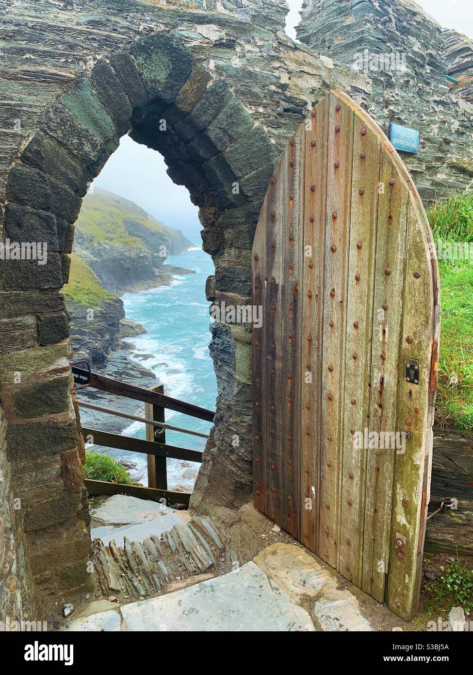 Mystical door opening at Tintagel Castle, Cornwall with the choppy sea ...