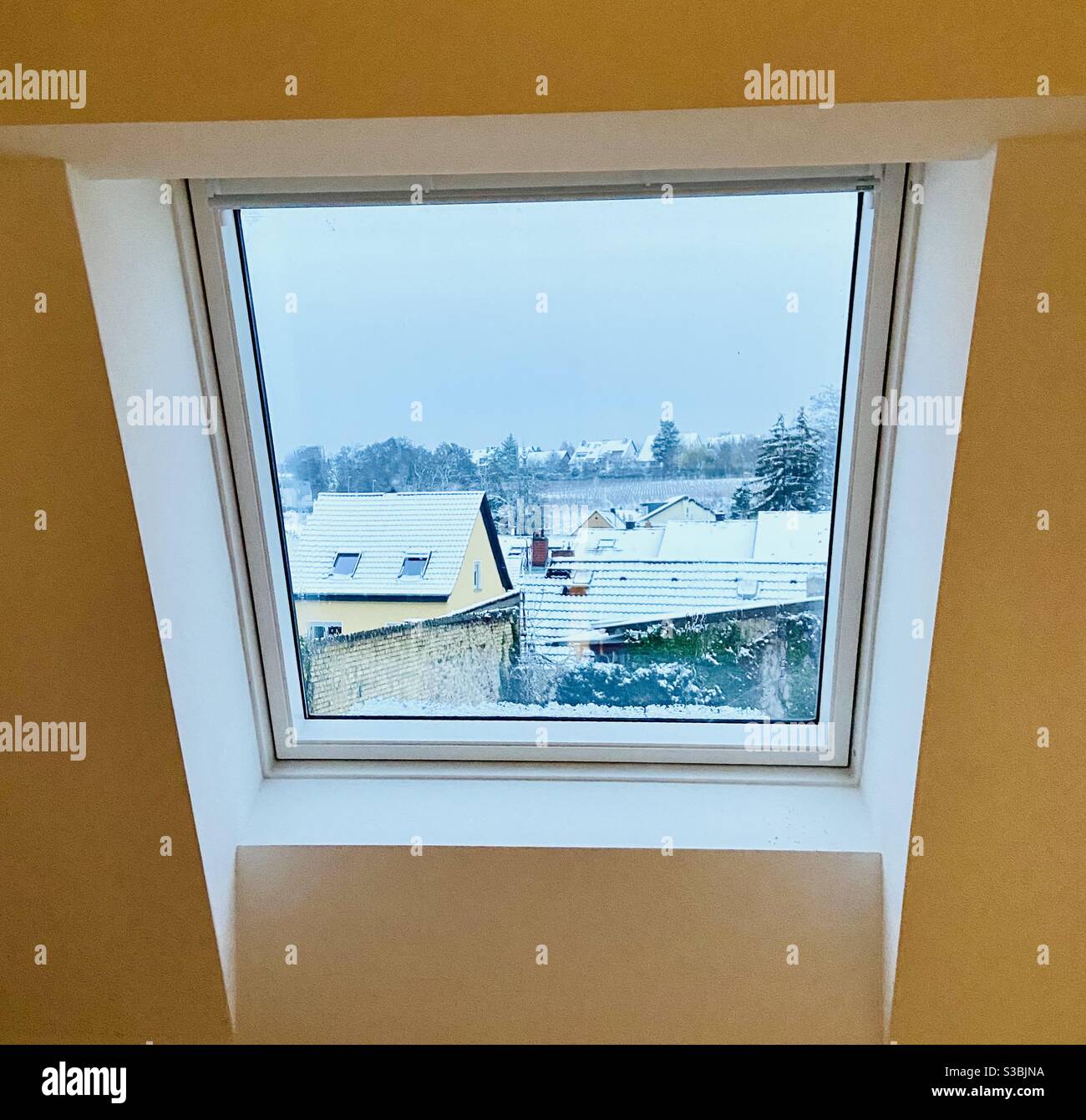 view out of a roof window on roofs with the first snow Stock Photo - Alamy