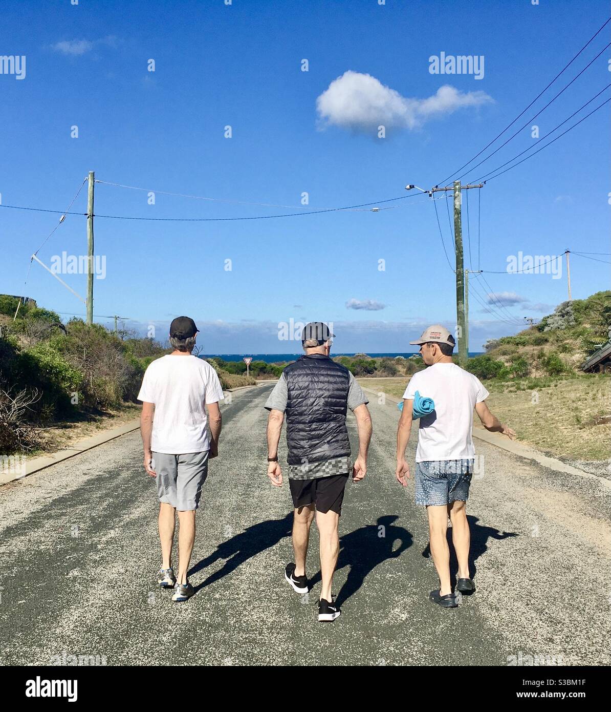 Three men walk hi-res stock photography and images - Alamy