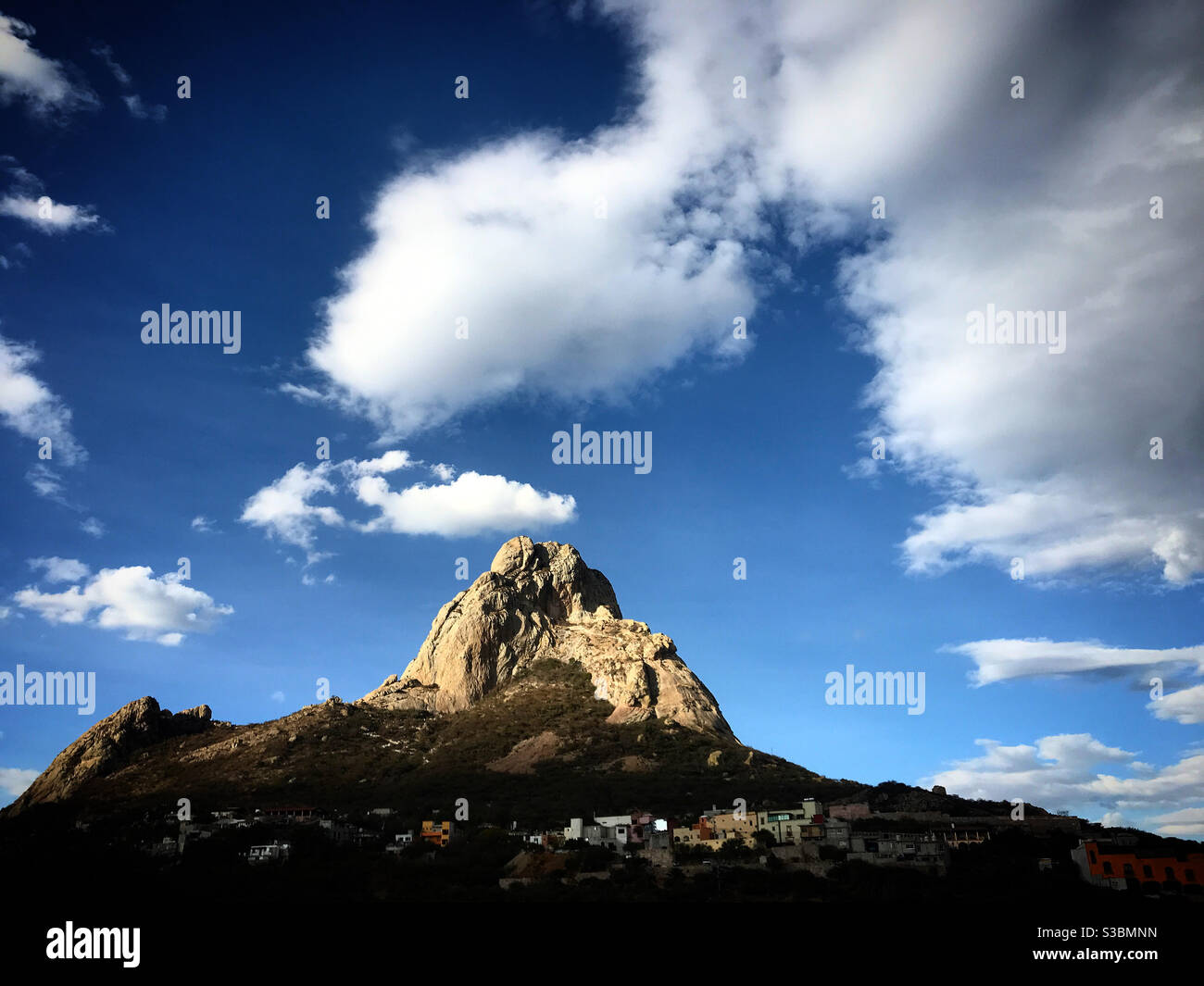 Clouds over the Peña de Bernal rock, the third biggest monolite in the ...