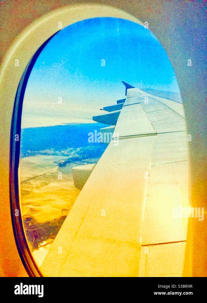 View out the window of an airplane overlooking the wing and scene ...