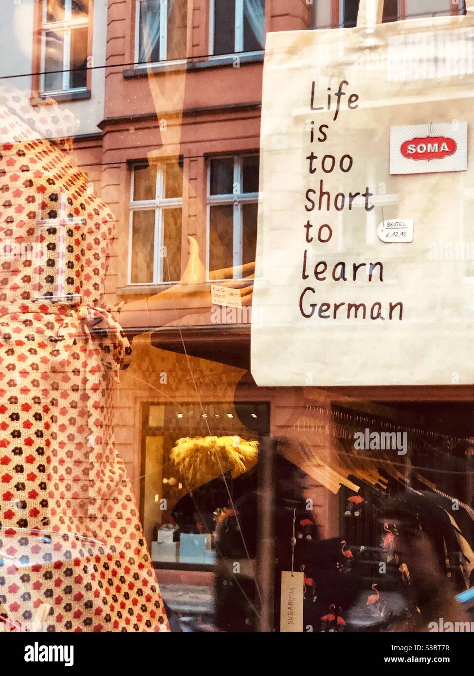Reflection in a Berlin store window captures the German architecture ...