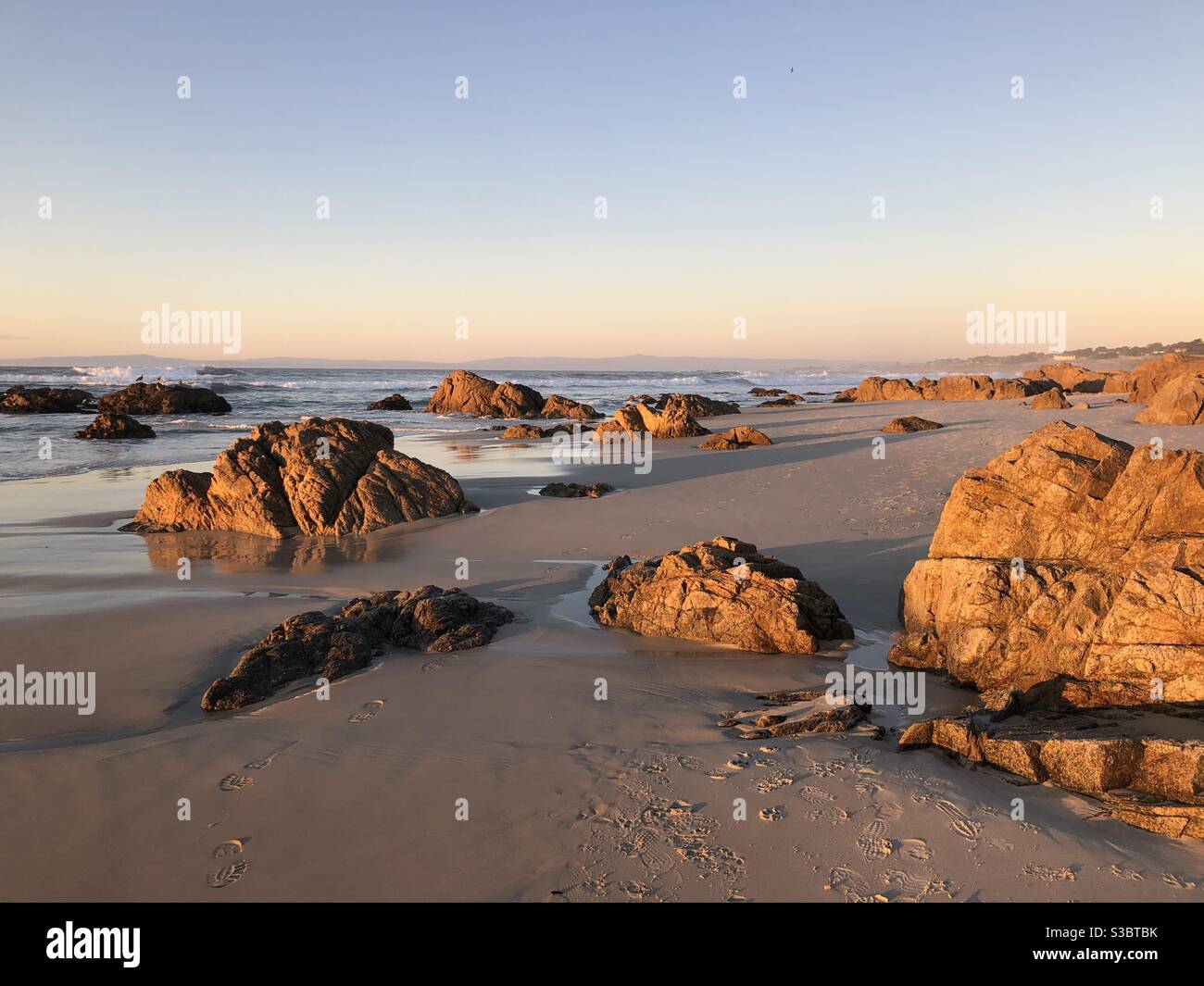 Rocks on a beach at low tide during golden hour, California Central ...