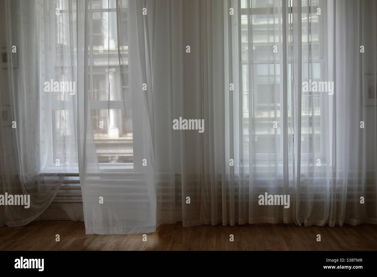 Empty room with windows, white transparent curtains Stock Photo - Alamy