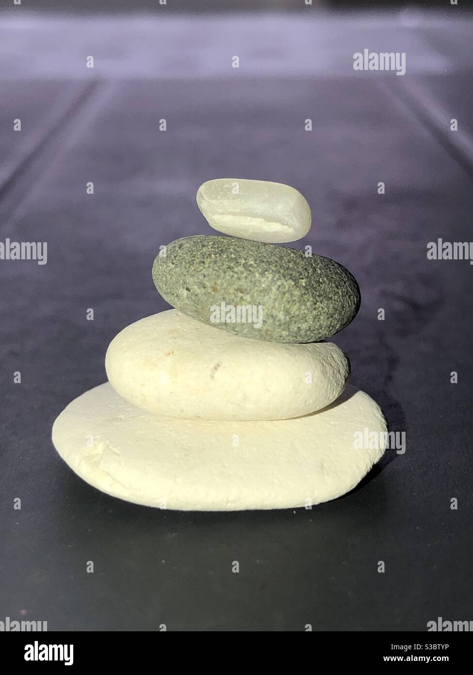 Desktop cairn of miniature pebbles Stock Photo - Alamy