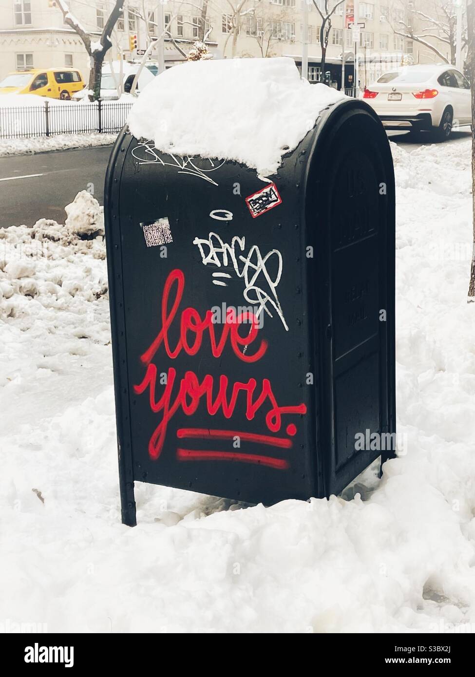 Red graffiti on a snow-covered mailbox on Park Avenue in New York City ...