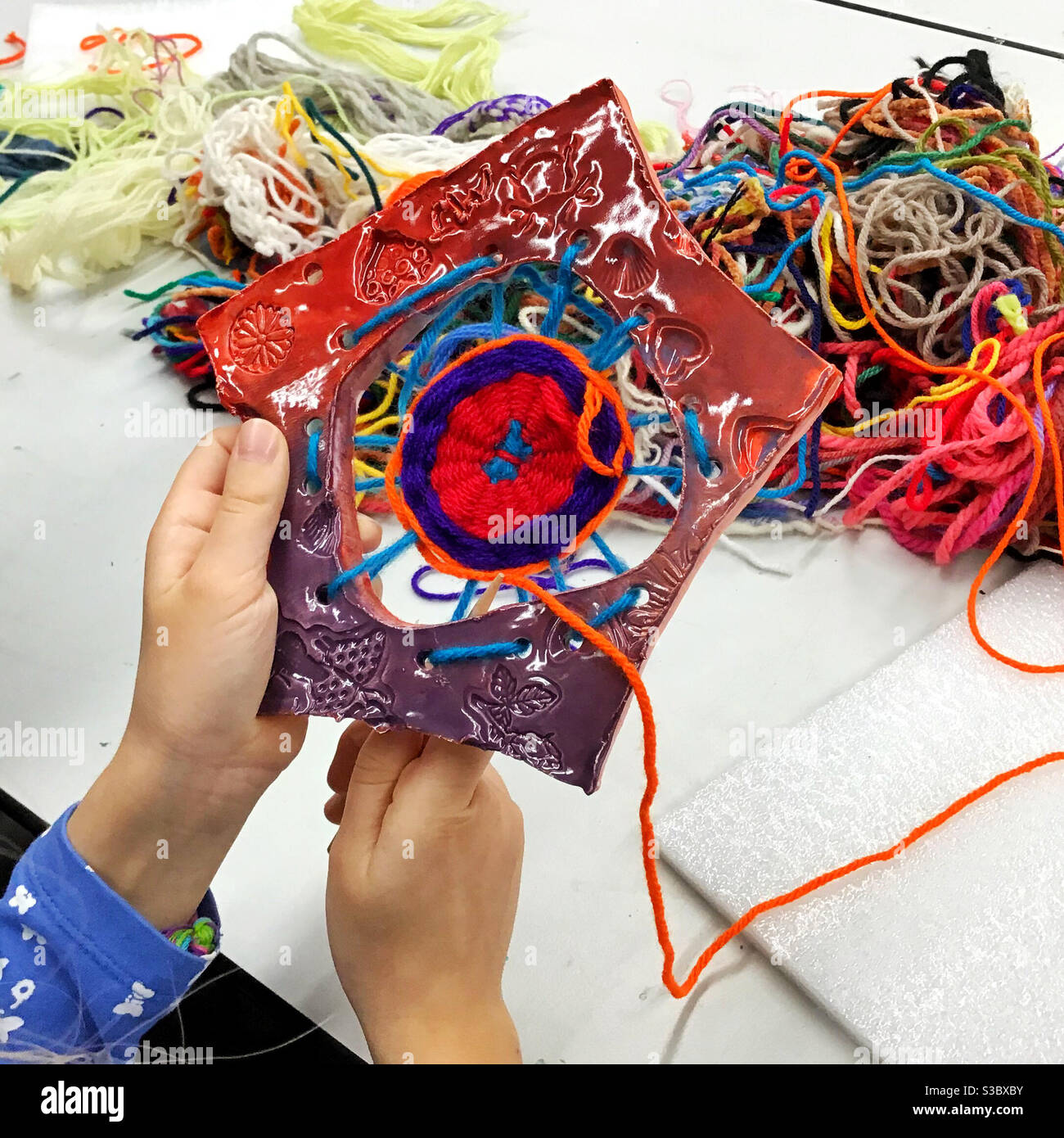 Child’s hands weaving on ceramic loom Stock Photo - Alamy