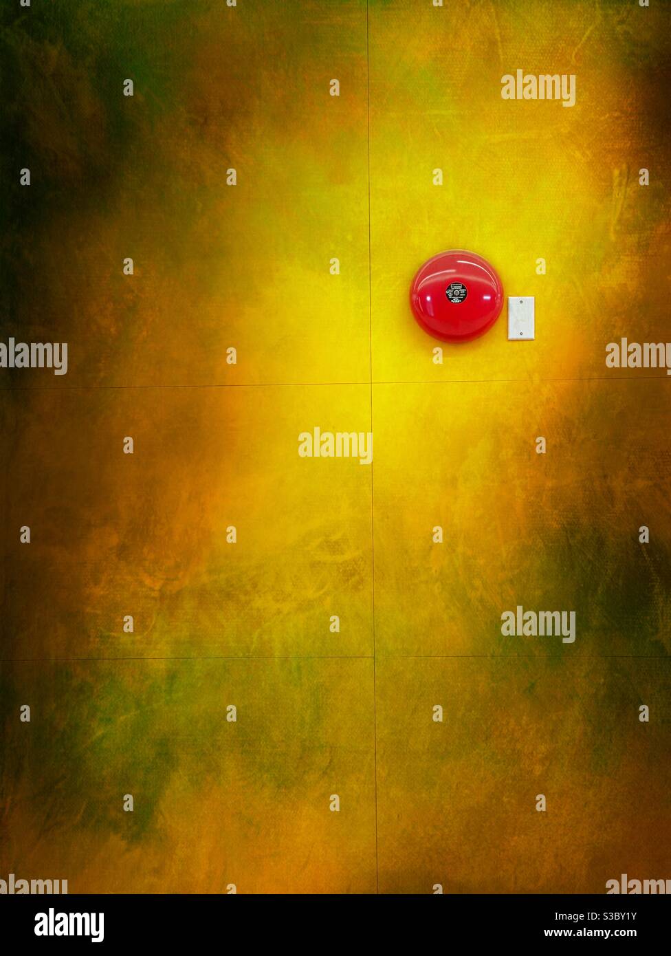 Red fire alarm on a textured yellow wall Stock Photo - Alamy