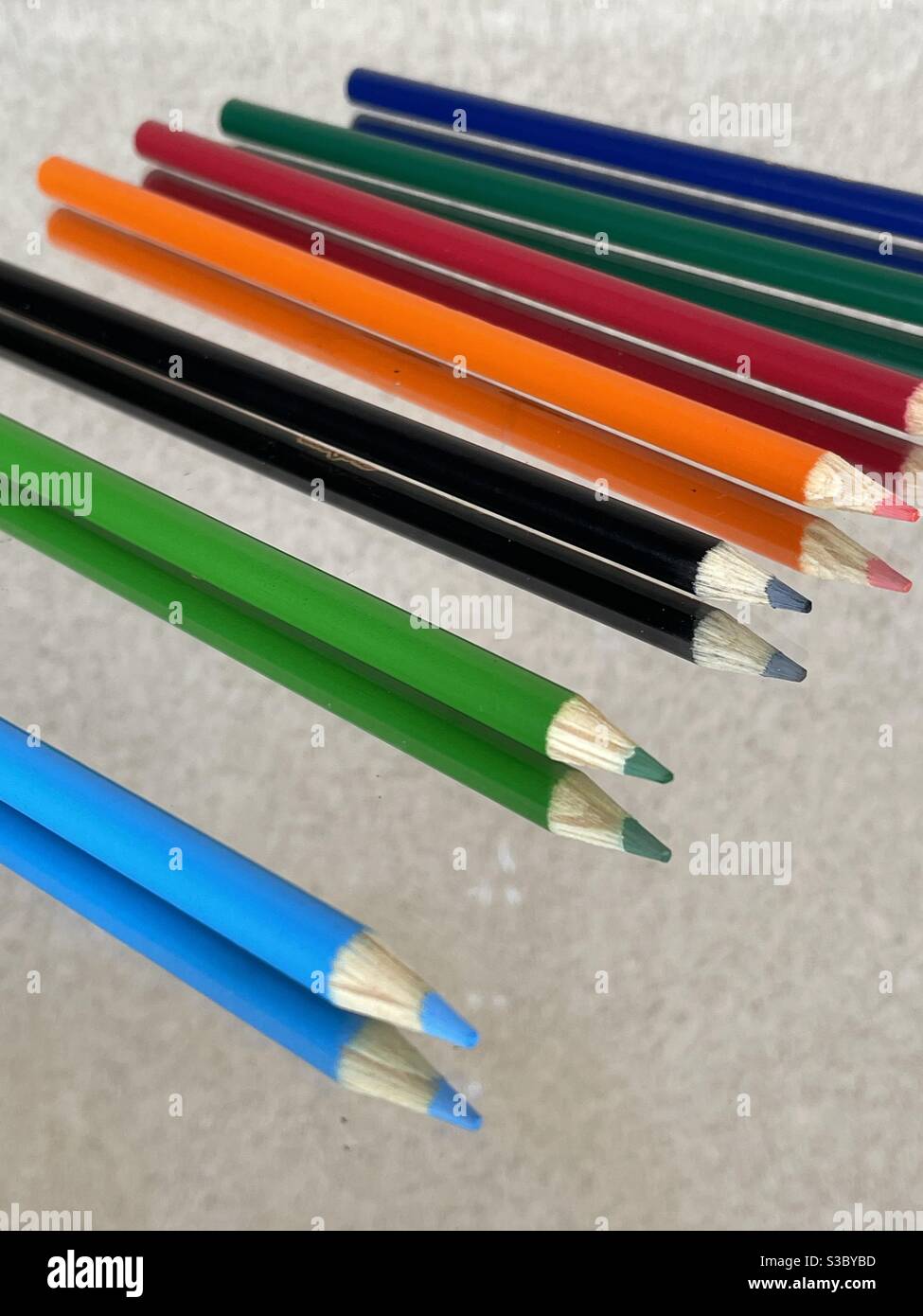 Colorful pencils with reflections on a mirrored surface Stock Photo - Alamy