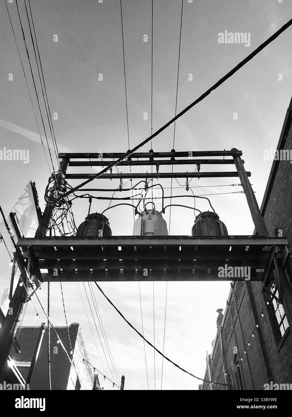 Wires and transformers in an alley Stock Photo - Alamy