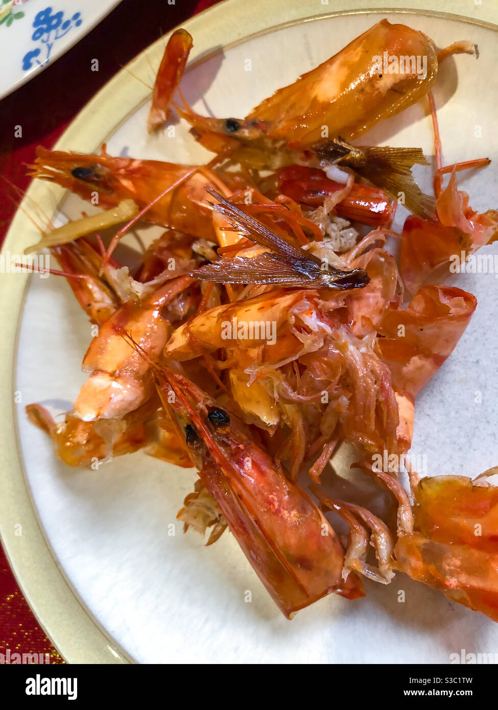 Prawn shells discarded on a side plate Stock Photo - Alamy