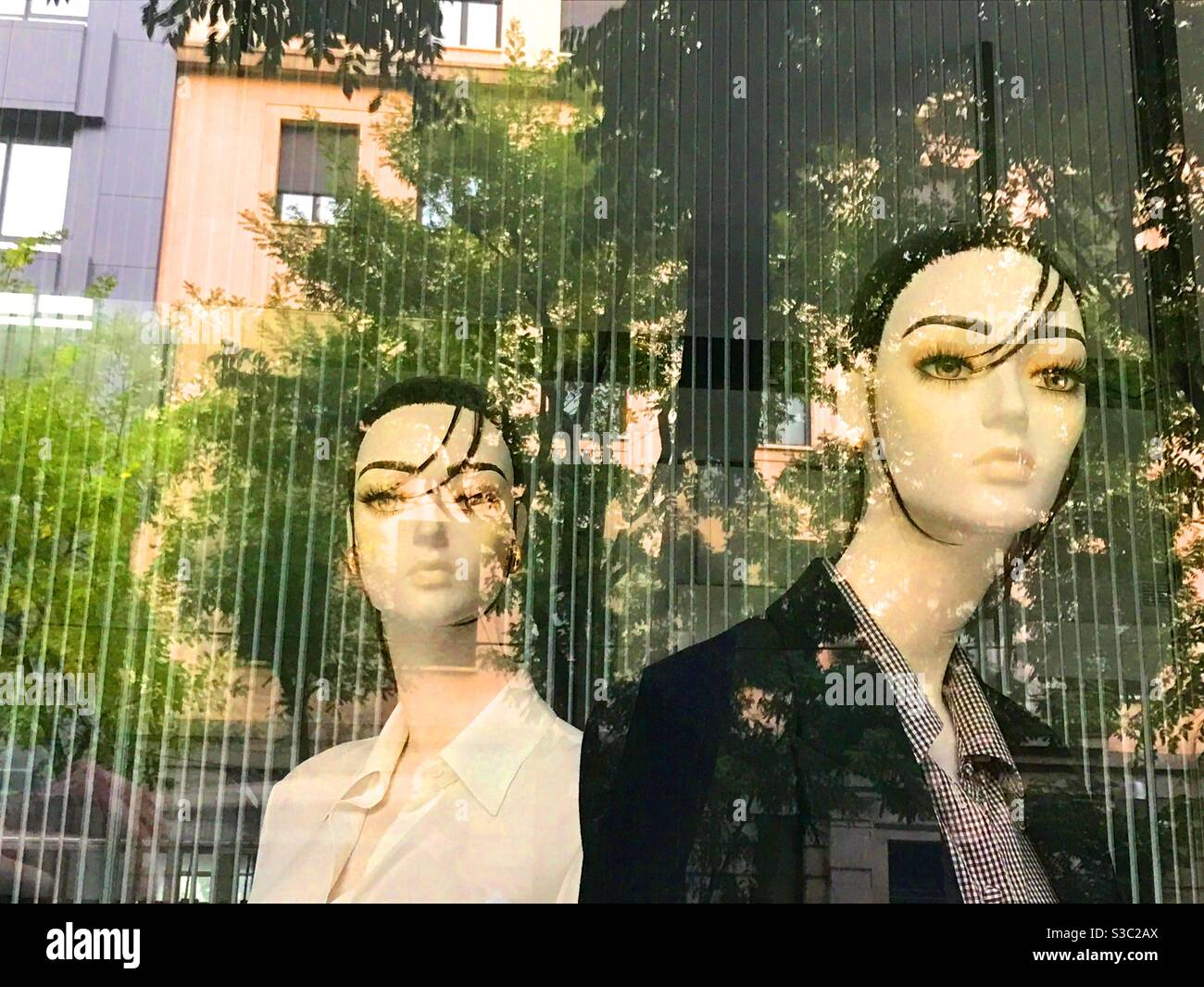 Two mannequins in a shop window Stock Photo - Alamy
