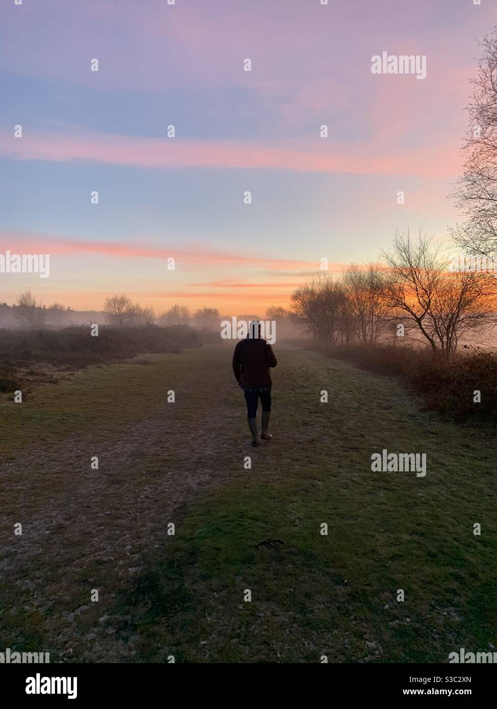 Lonely single man silhouette walks along English countryside path in ...