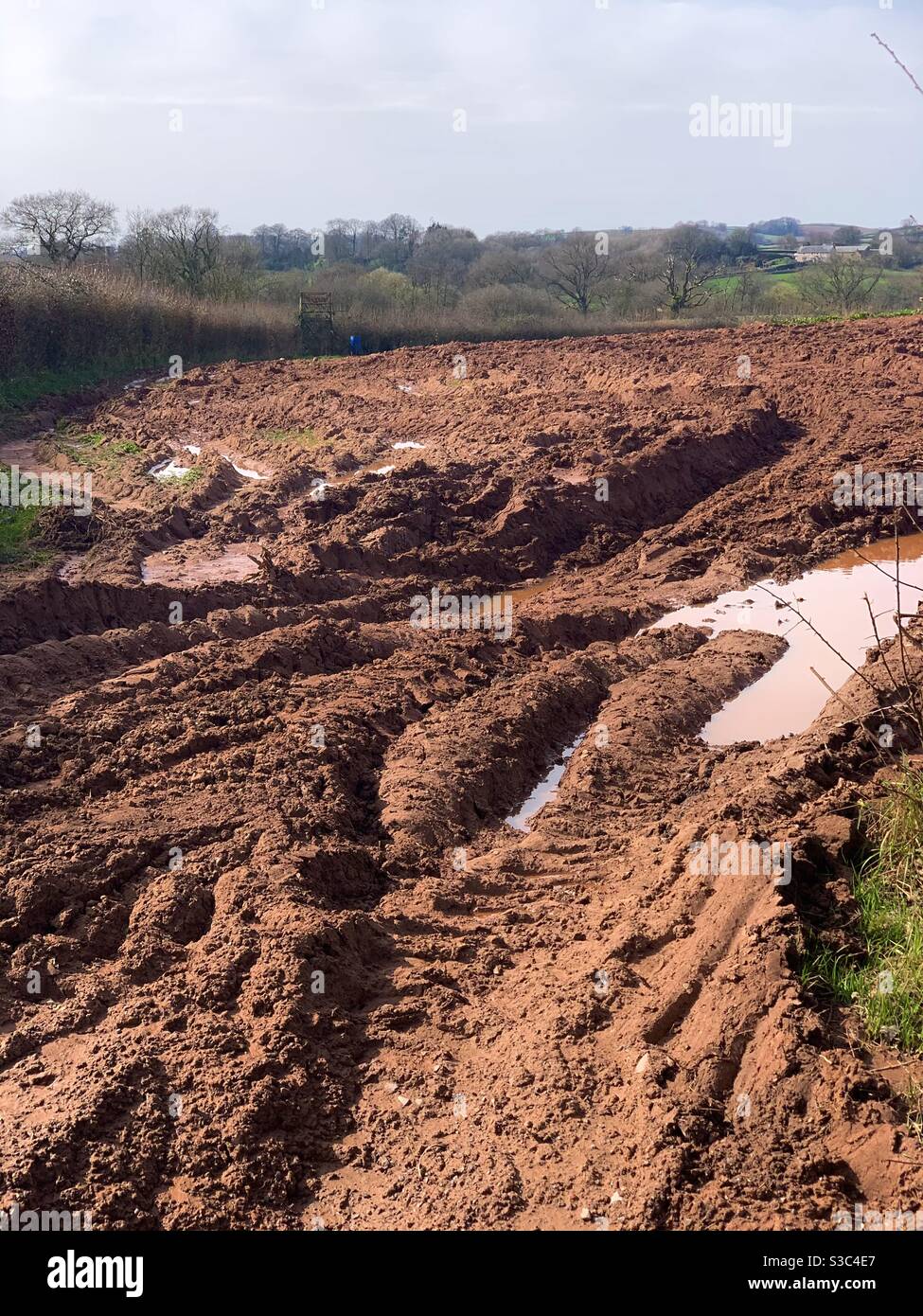 Muddy waterlogged country field in springtime, March 202 England ...