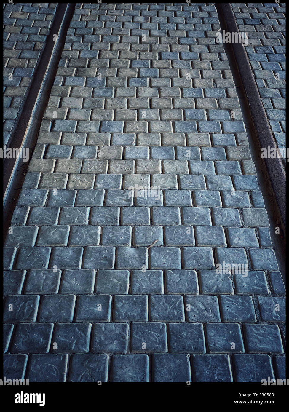 Cobblestone path with tracks Stock Photo - Alamy