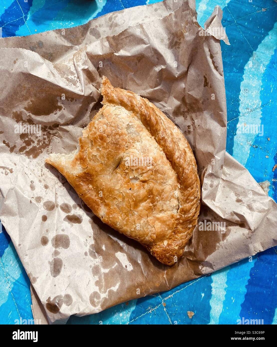 Cornish pasty on paper bag and blanket Stock Photo - Alamy