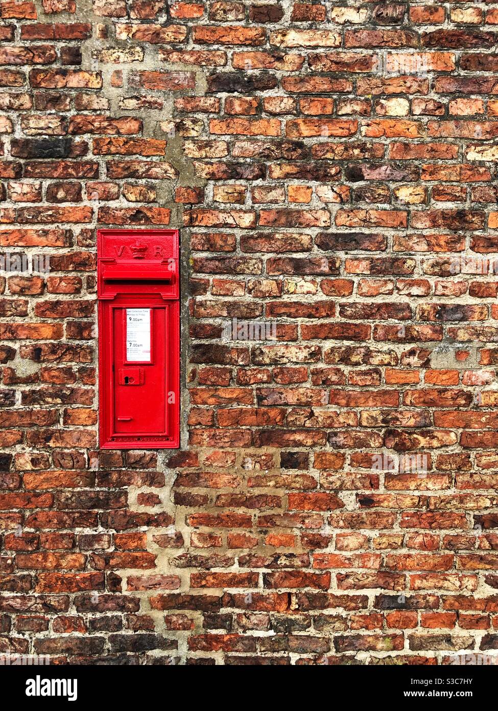 A Royal Mail red post box on a brick wall with copy space Stock Photo ...