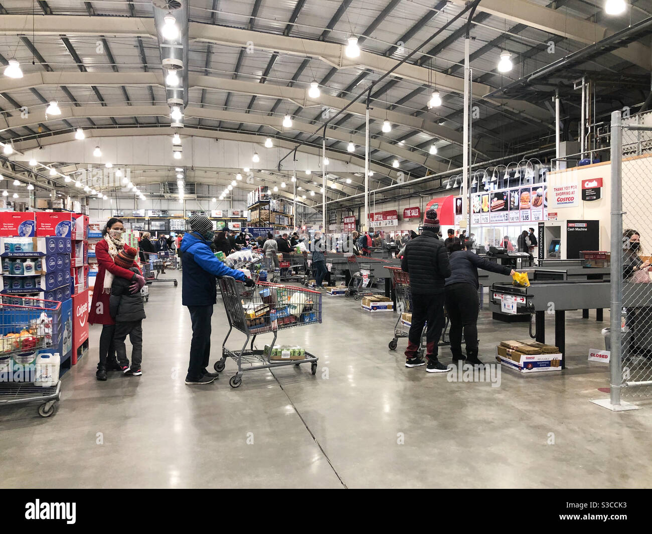 People. queuing to pat for goods in a wholesale warehouse store Stock ...