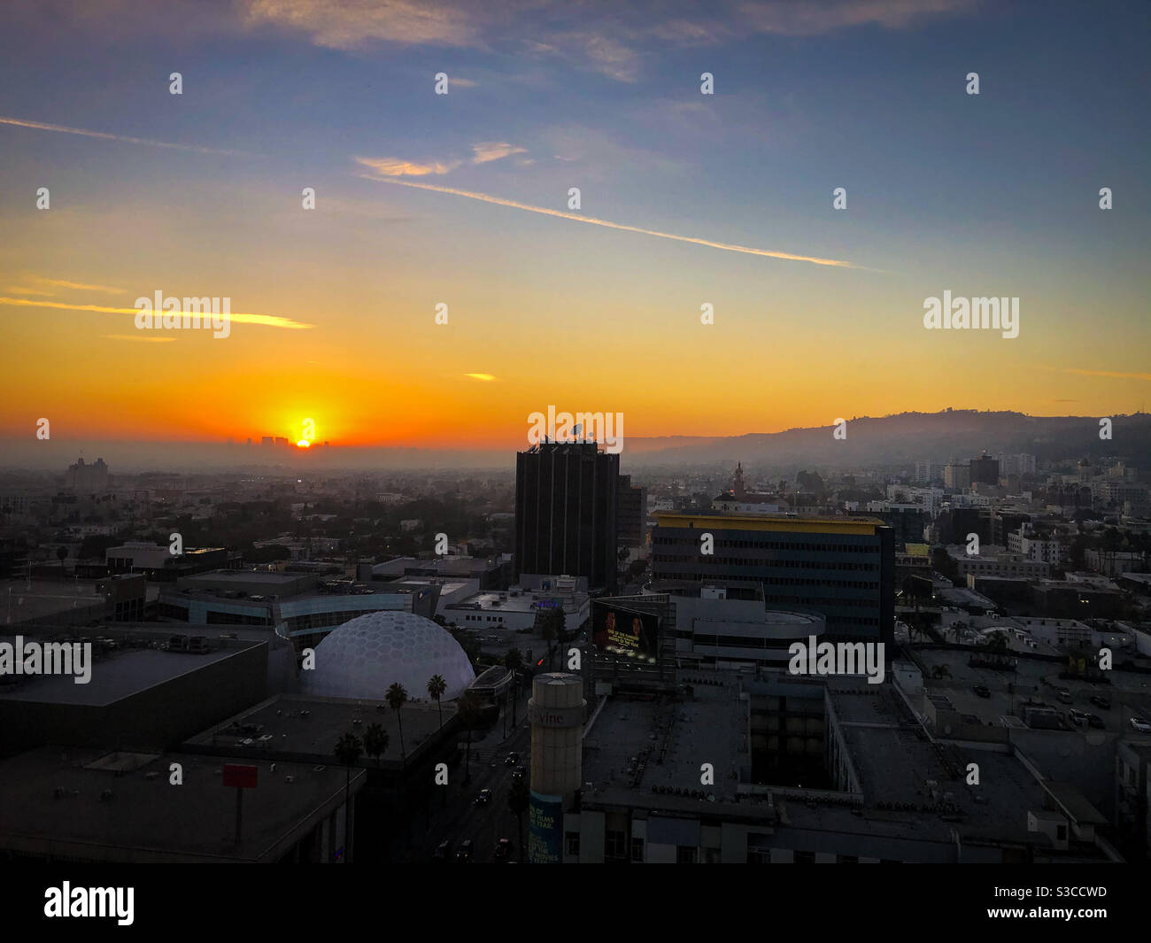 Sunset sky over city Stock Photo - Alamy