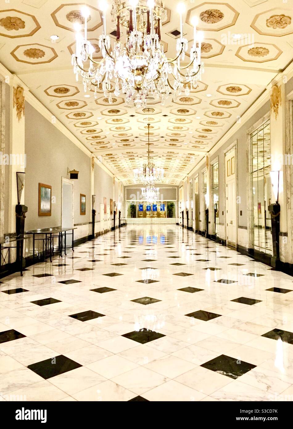 Interior view of a hallway in a luxury hotel showing gold ceiling work ...