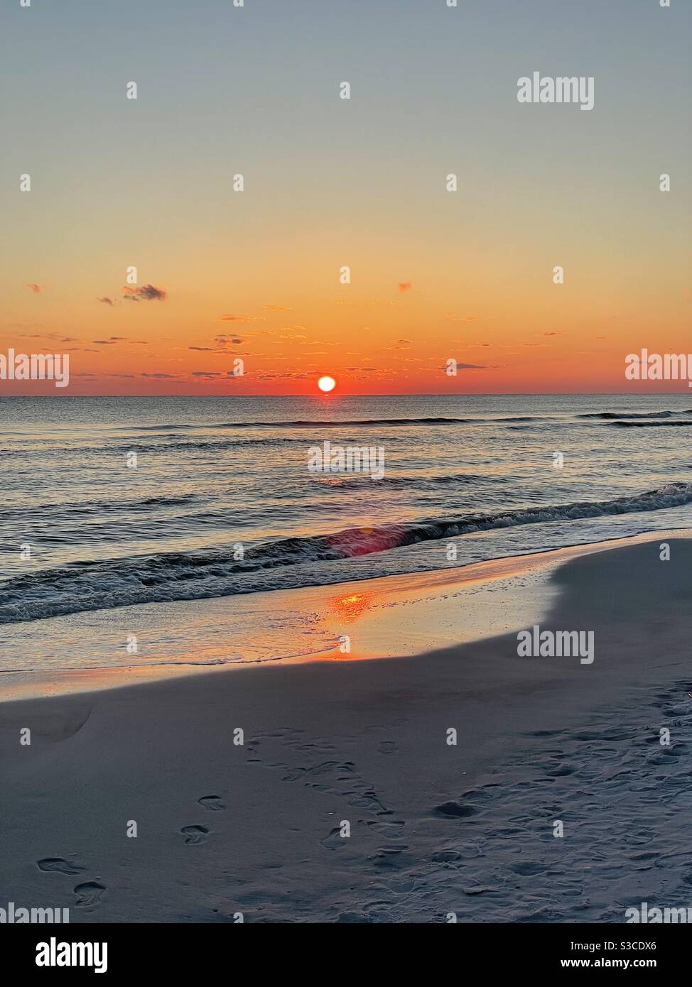 Golden sunset over the emerald colored water of the Gulf of Mexico ...