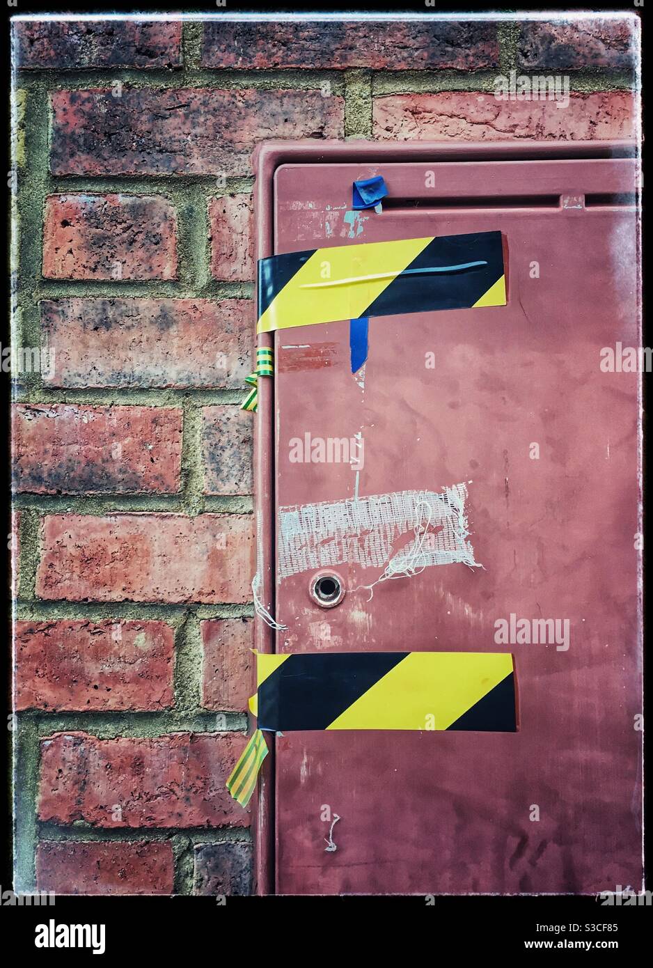 Broken meter cupboard patched up with black and yellow tape Stock Photo ...