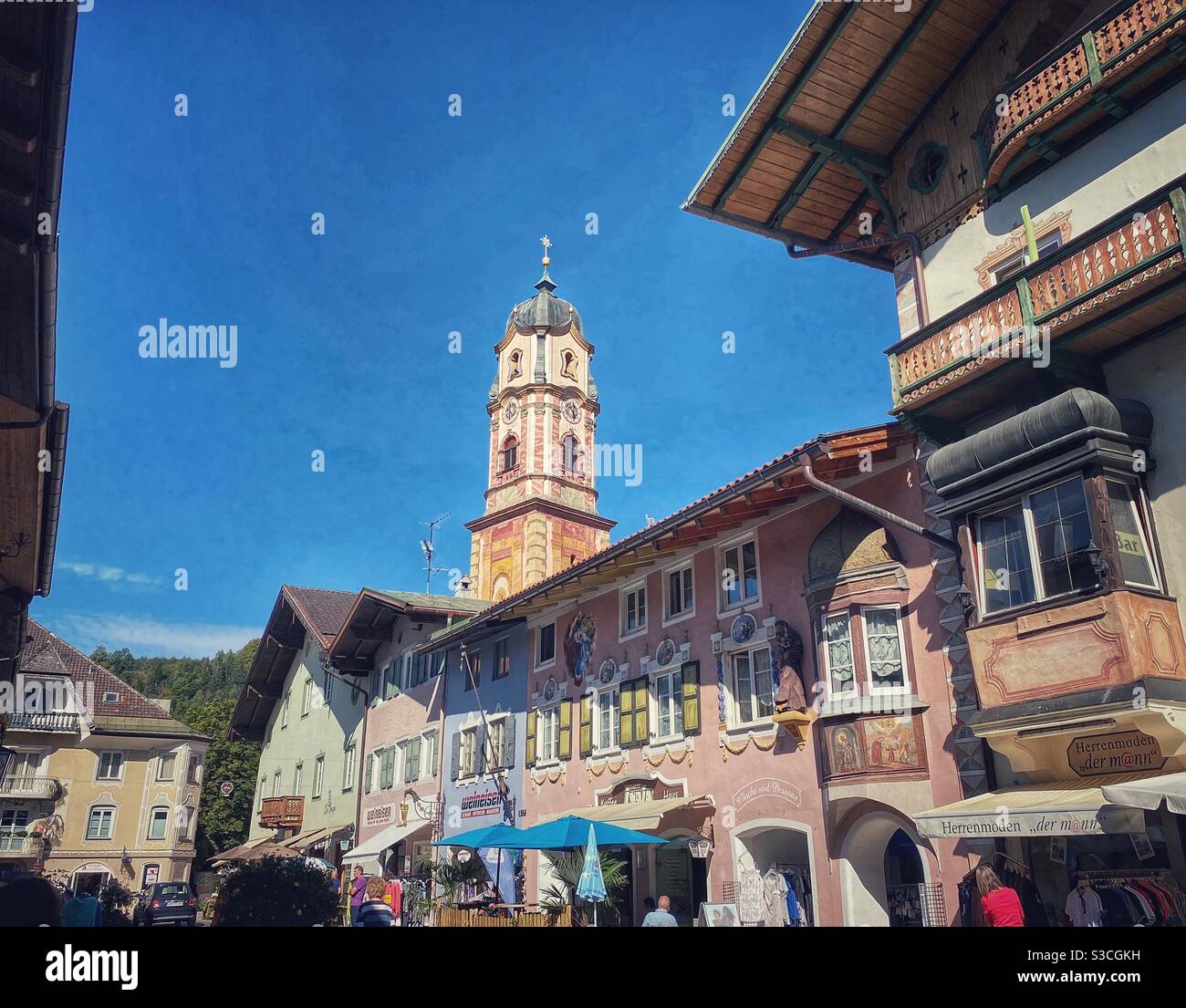 Traditional Bavarian Colorful houses and Church tower in Mittenwald ...