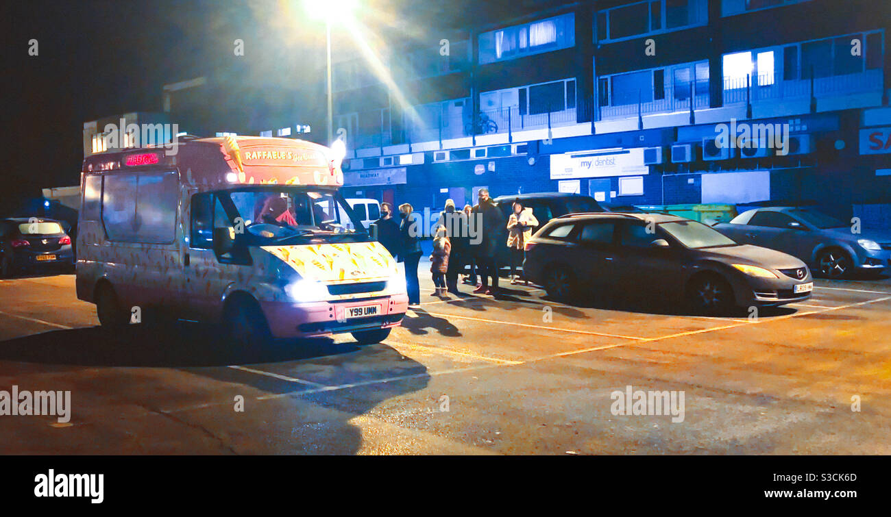 People queuing at an ice cream van parked in a car park at night Stock ...