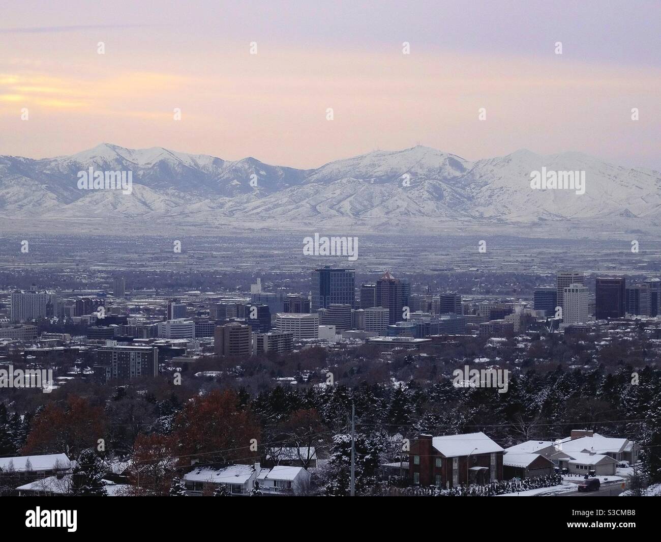 Salt Lake City, Utah sits below snow covered mountain peaks in the ...