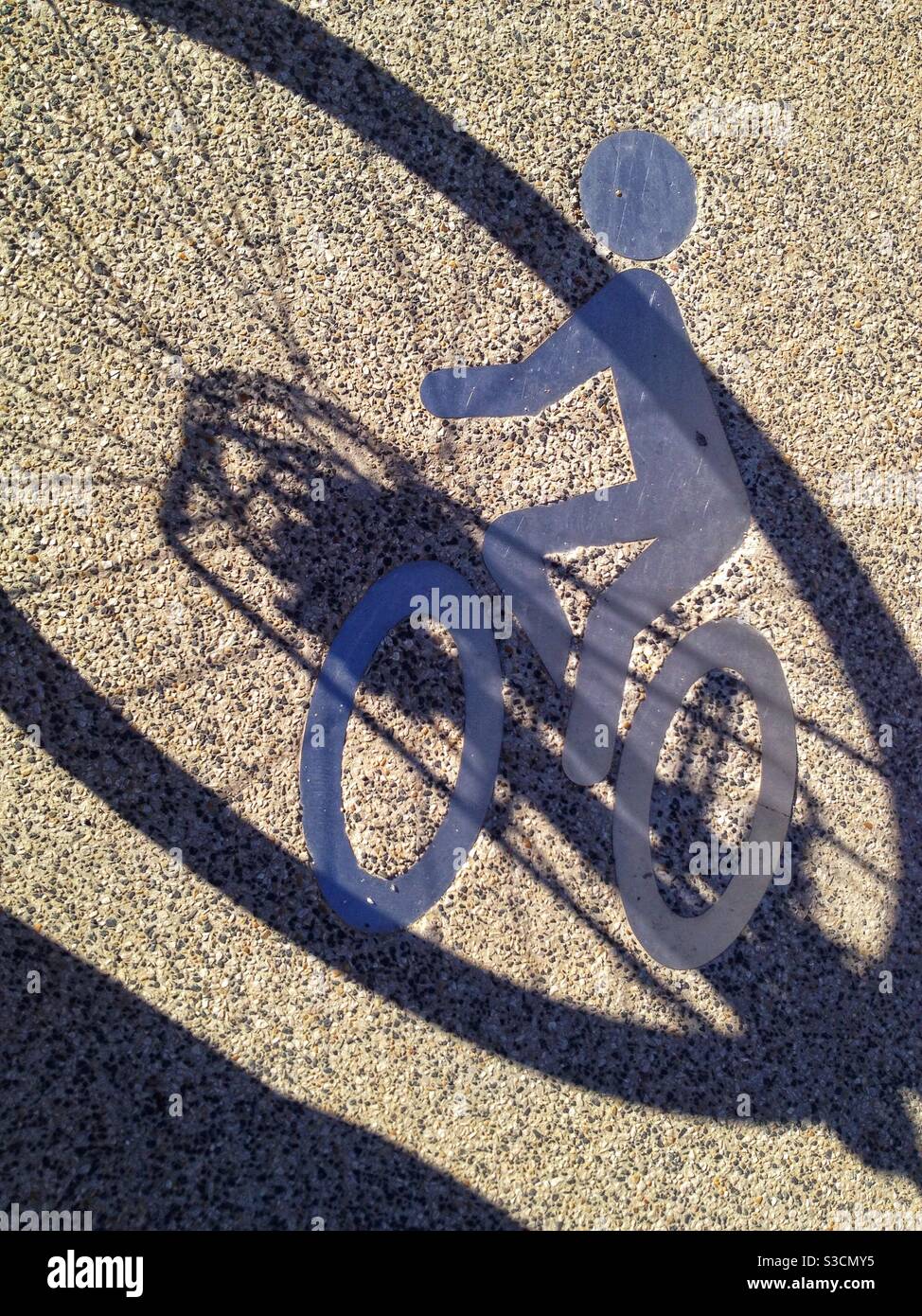 Metal Pictogram on a cycle path and shadow Stock Photo - Alamy