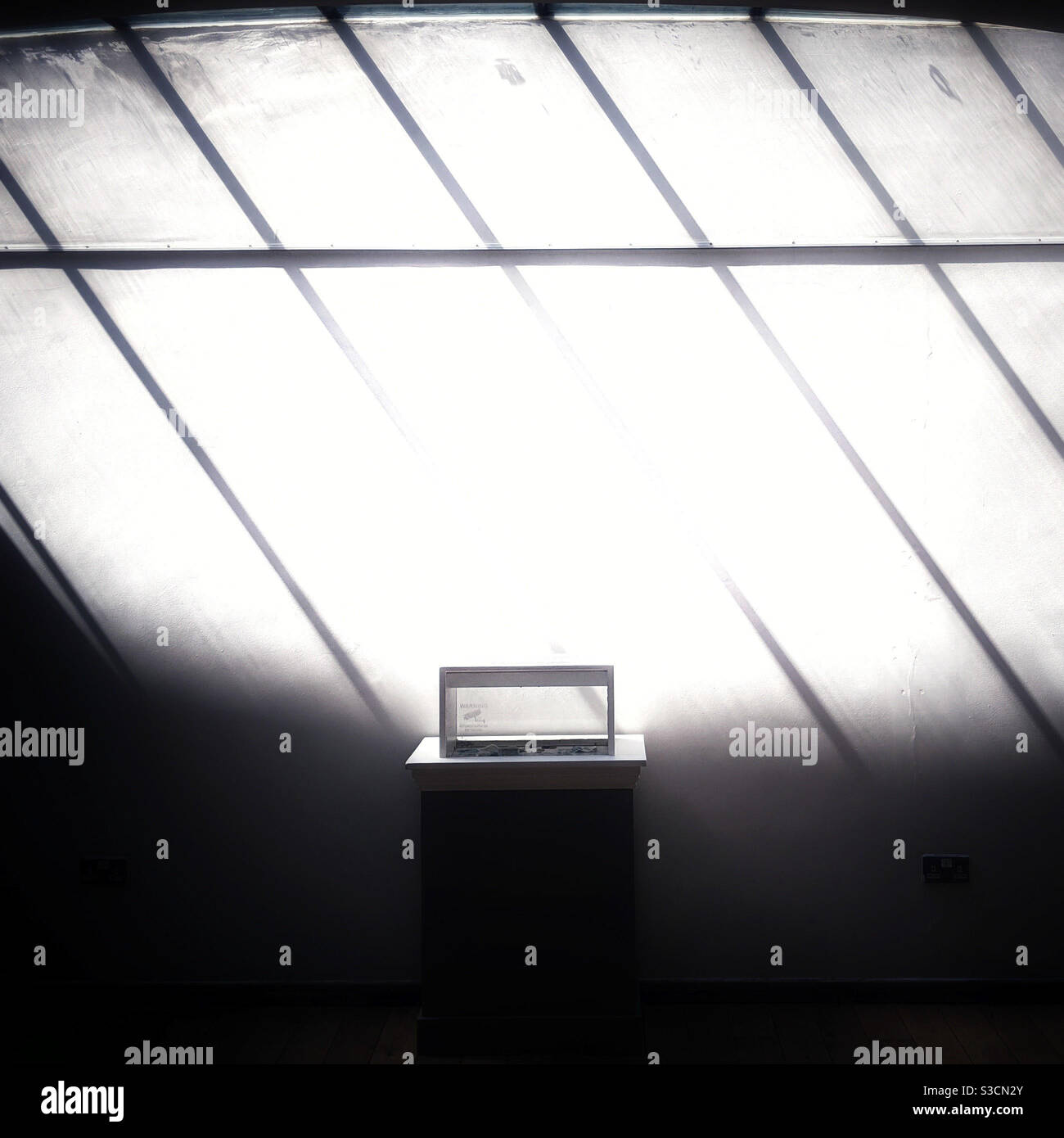 Light shining on money donation collection box Stock Photo - Alamy