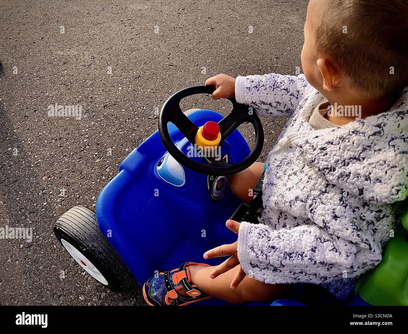 Child pushing toy car hi-res stock photography and images - Alamy