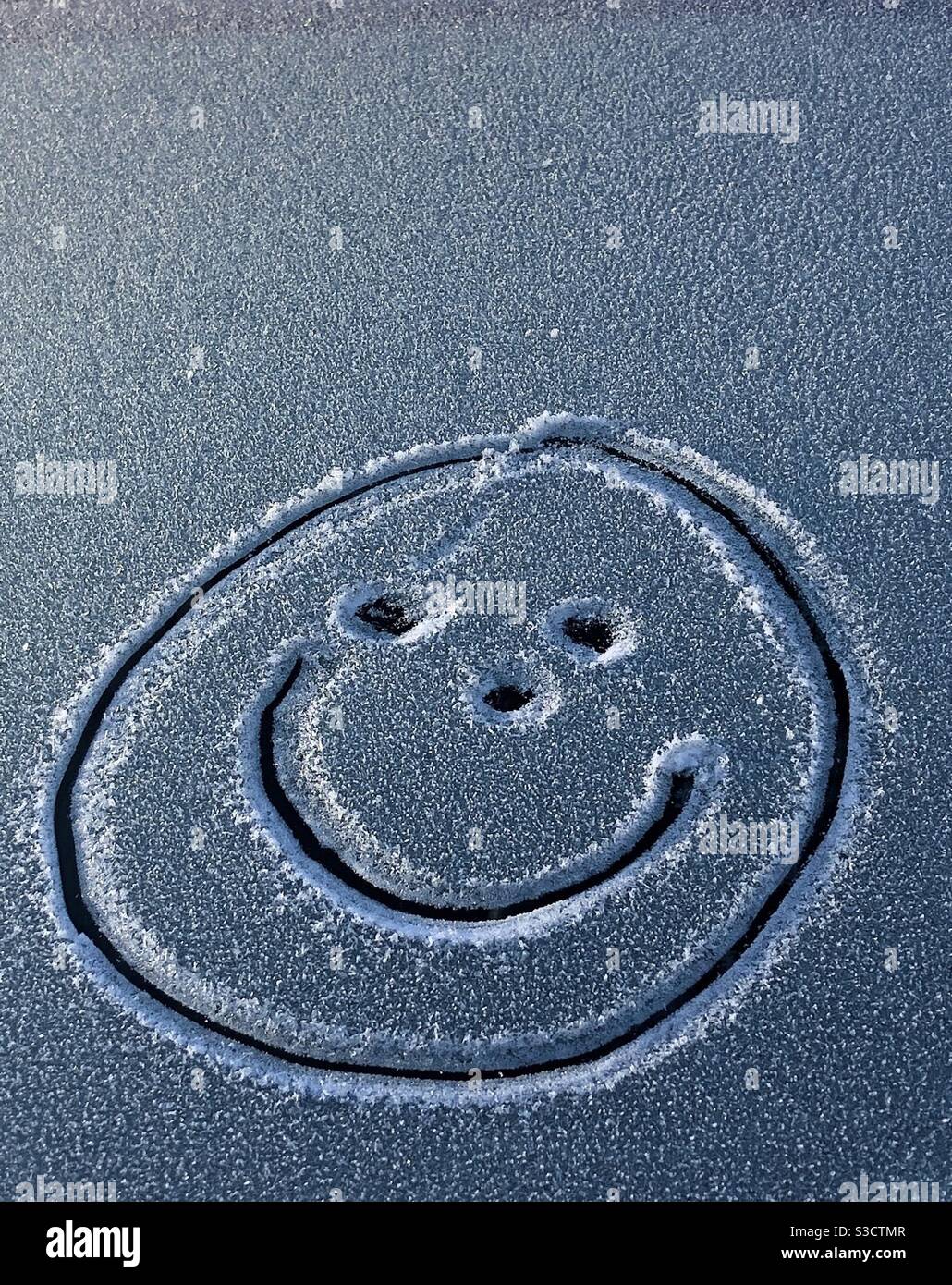 Smiley face drawn in thick frost on a windscreen Stock Photo - Alamy