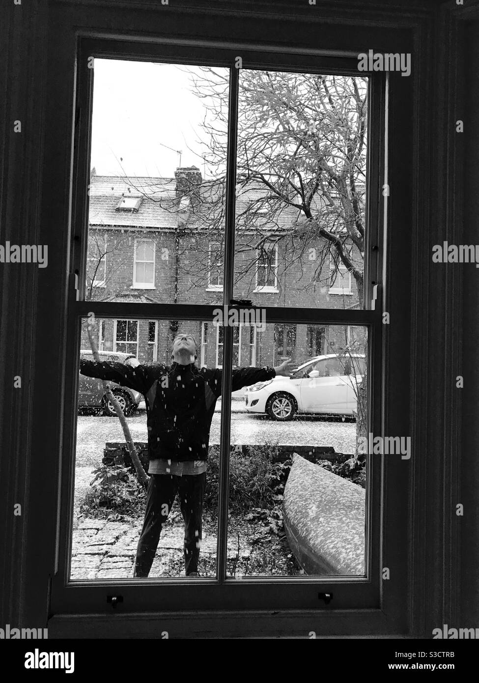 View through window of man in snowfall Stock Photo - Alamy