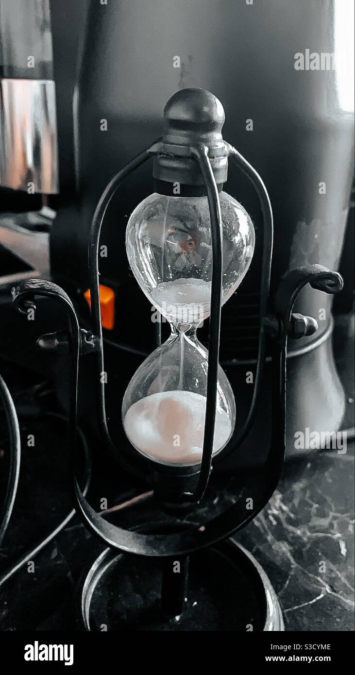 Black and white hourglass in a coffee shop Stock Photo - Alamy