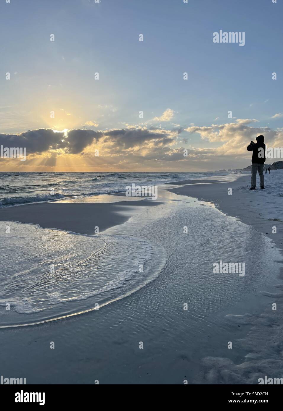 Man taking pictures of sunset on white sand beach Florida beach Stock ...